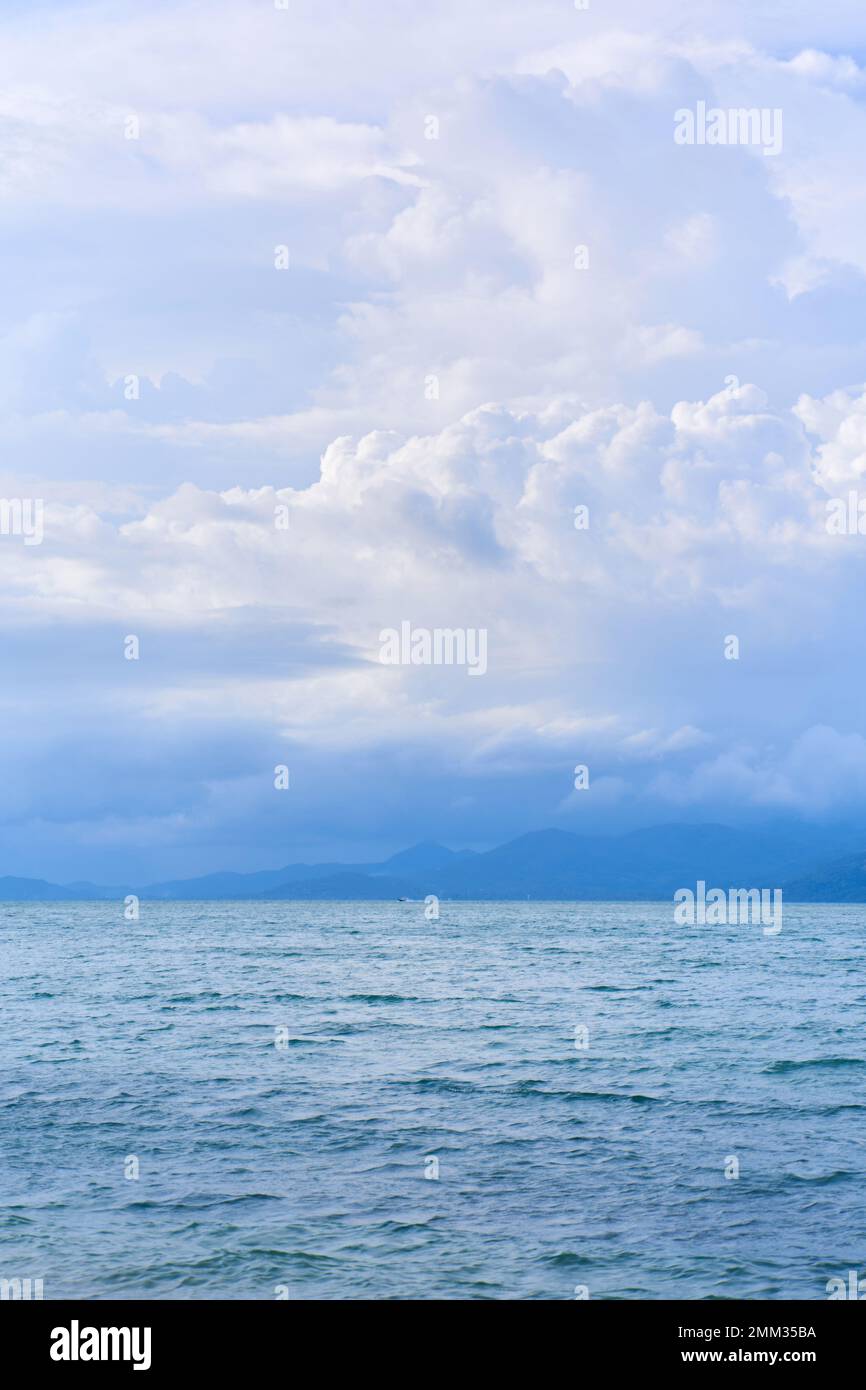 Rain clouds over an island in the sea. The rain is coming Stock Photo ...