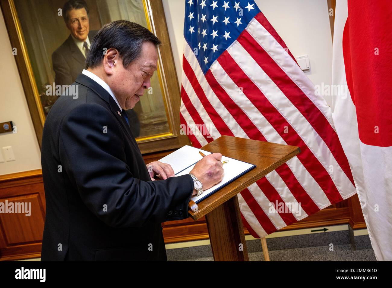 Japan's Minister of Defense Yasukazu Hamada signs the guest book before ...