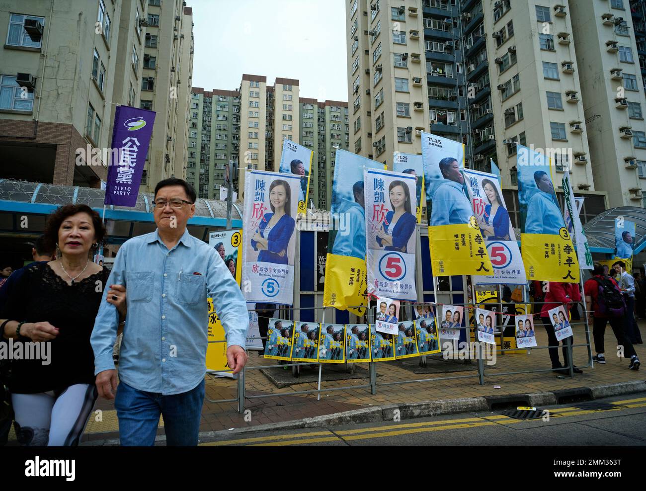 People walk past banners of pro-democracy, candidate Lee Cheuk-yan, No ...