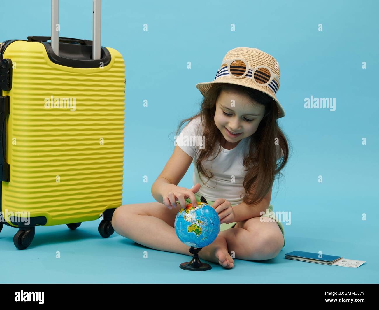 Cute Caucasian little girl, a tourist traveler in summer clothes and ...