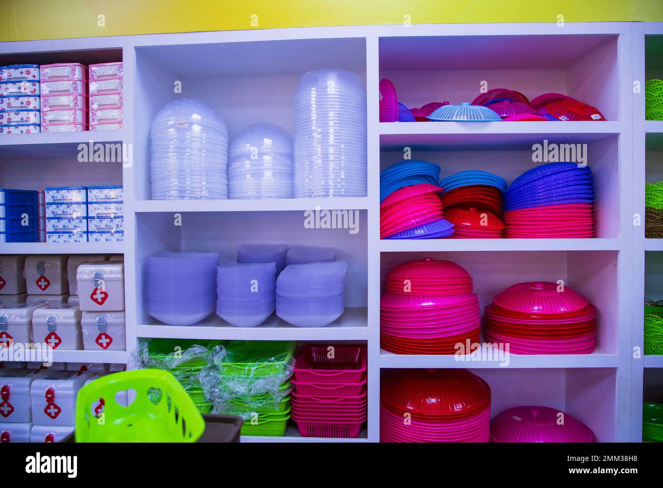 Colorful plastic tableware on shelves in the super shop. Close-up Stock ...
