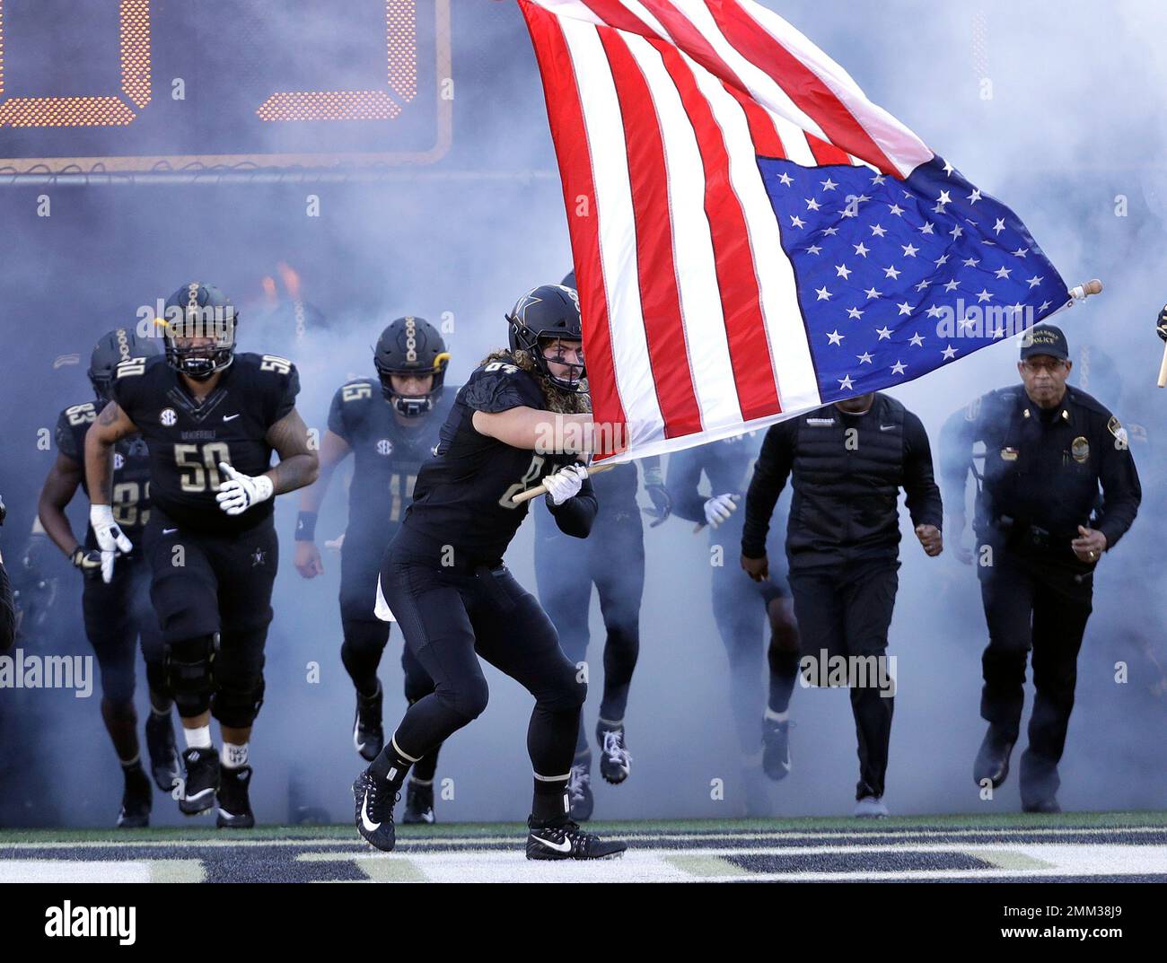 Vanderbilt tight end Sam Dobbs (84) carries a flag as the team takes ...