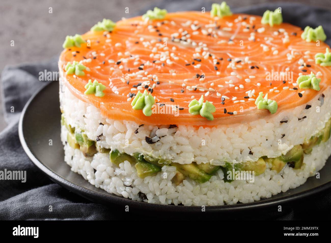 Delicious philadelphia sushi cake with red fish, rice, avocado, cream ...