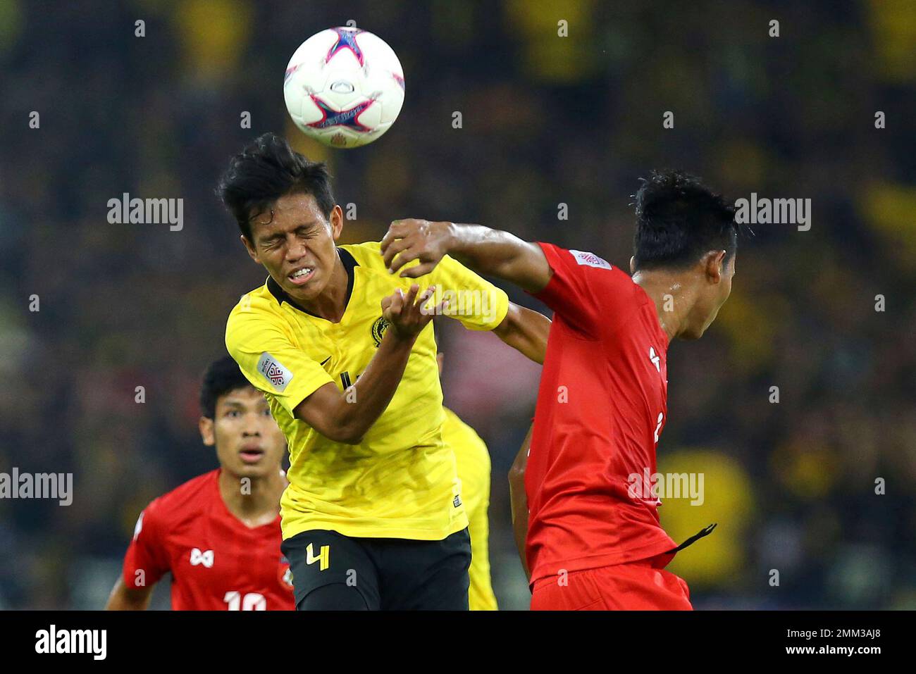 Malaysia's Muhammad Syahmi Safari, right, battles for the ball with ...