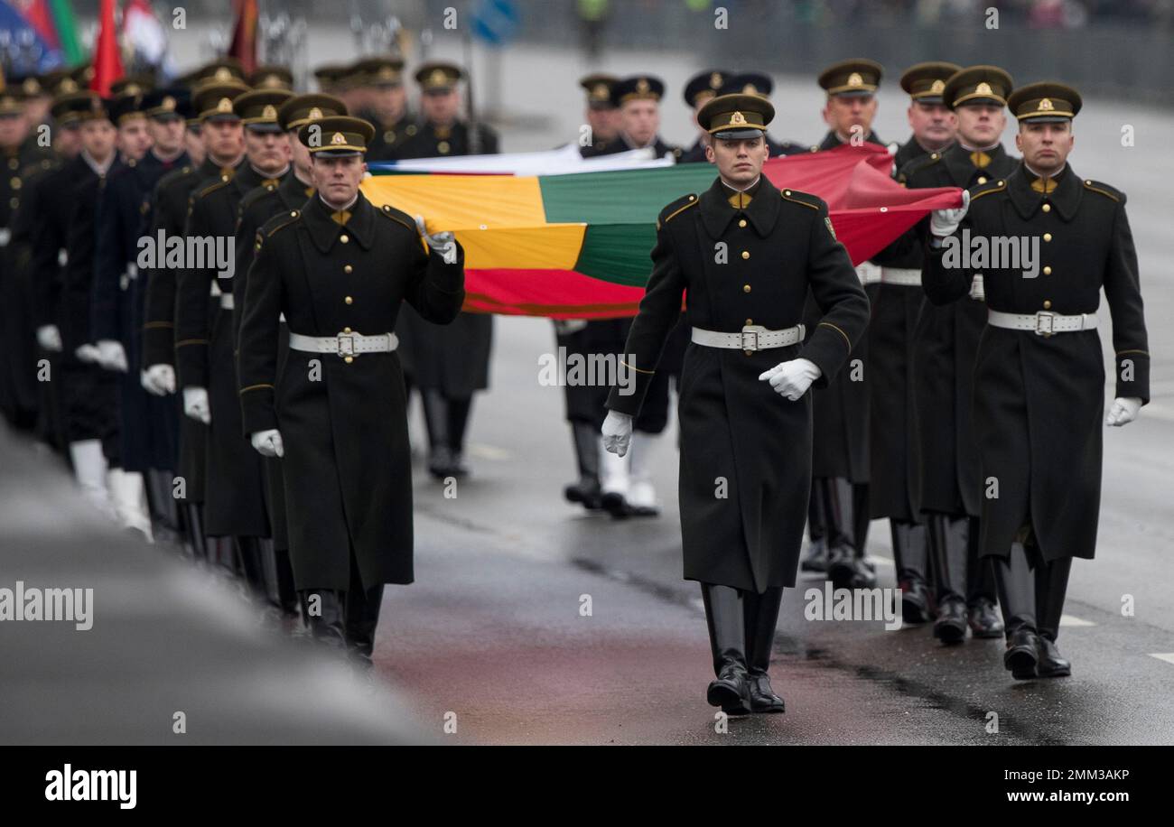 Soldiers carry a Lithuanian flag during the military parade to ...