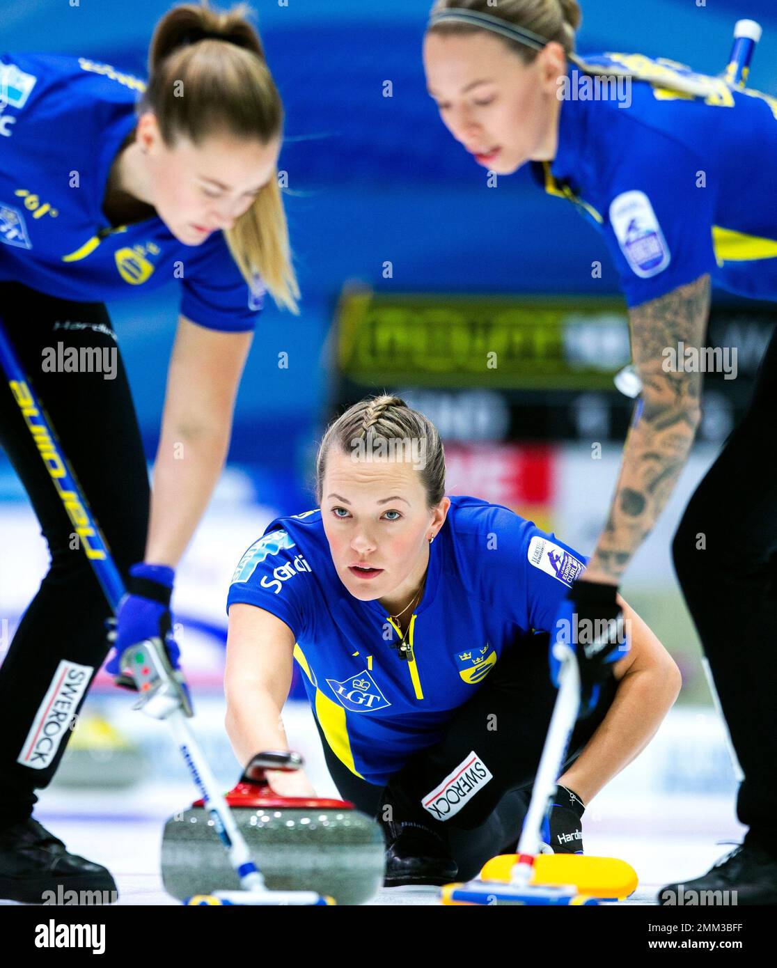 Sweden's Anna Hasselborg, center, delivers a stone as Sara McManus ...