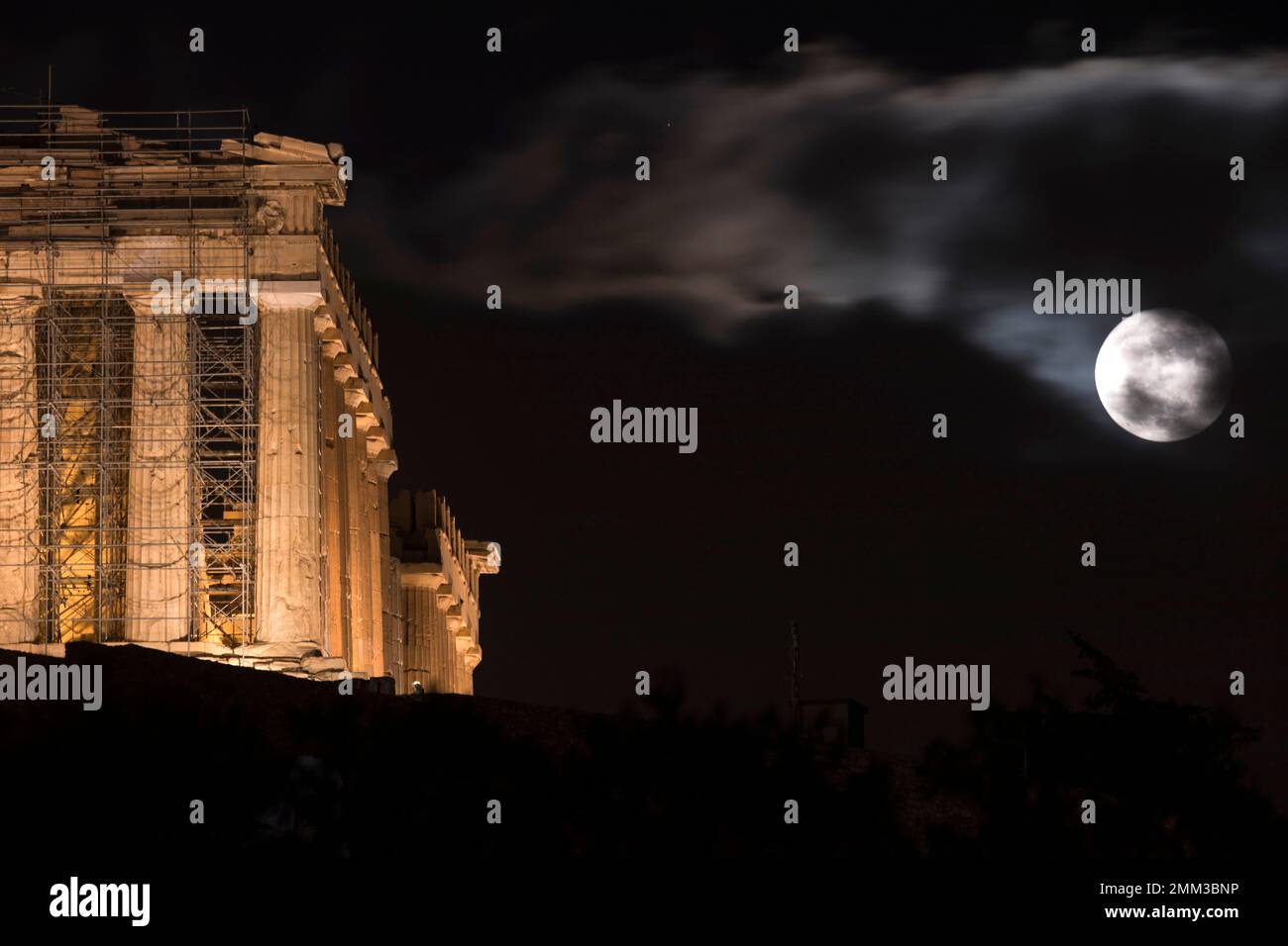 The full moon rises behind the 2,500-year-old Parthenon temple on the ...
