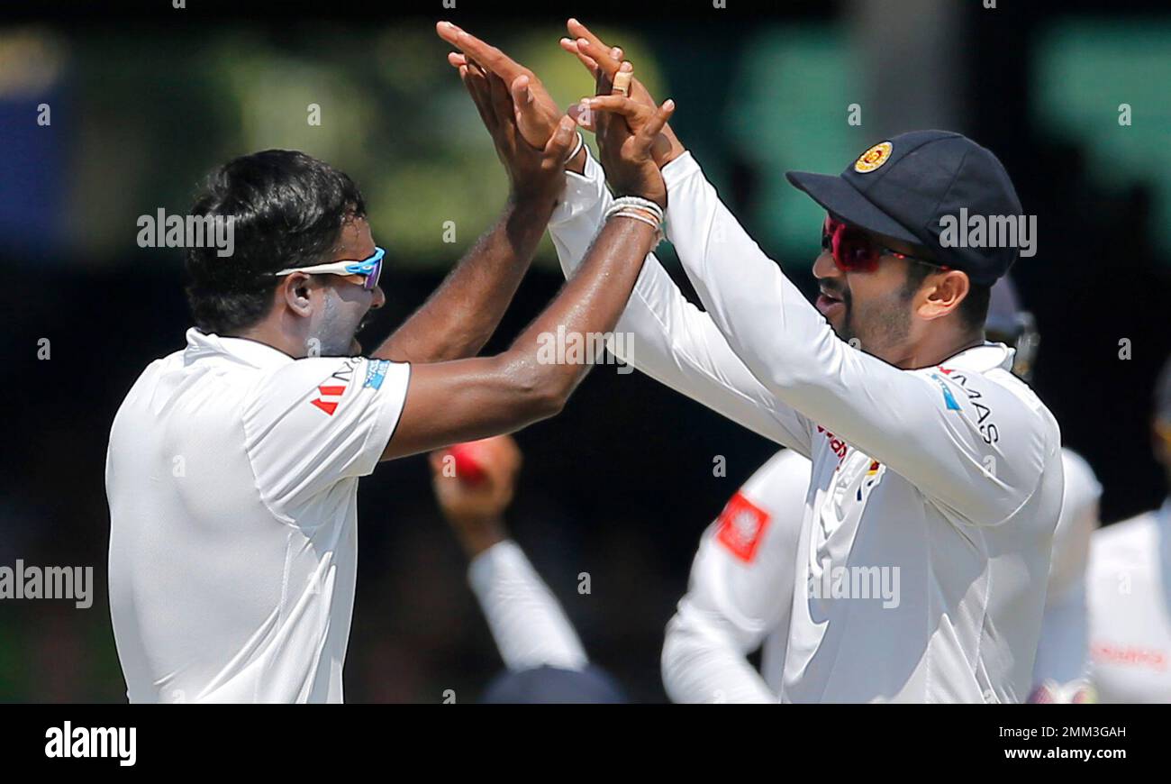 Sri Lanka's Malinda Pushpakumara, left, celebrates taking the wicket of ...
