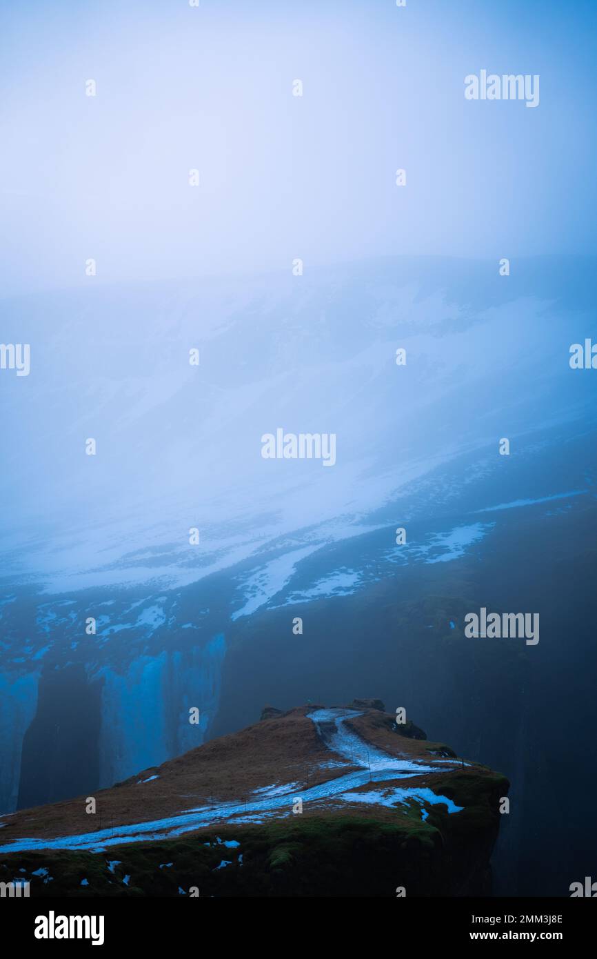 foggy mountain snow with frozen waterfall Stock Photo - Alamy