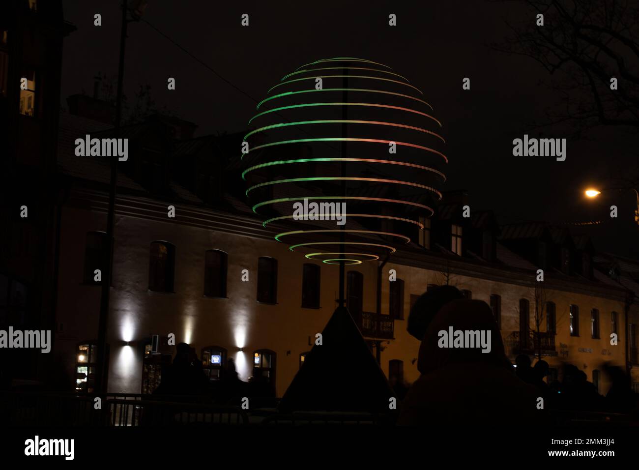 photo of a glowing circular installation on the street at night Stock ...
