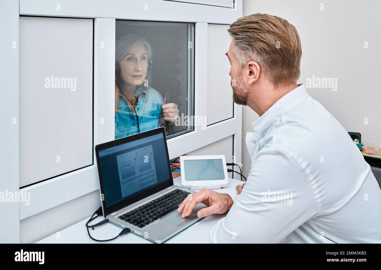 Audiometric testing. Mature woman getting hearing test and audiometry ...