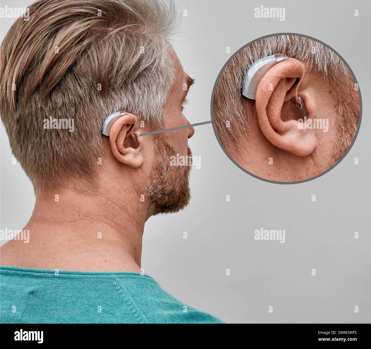 Improving hearing with hearing aids. Hearing aid behind the ear of ...