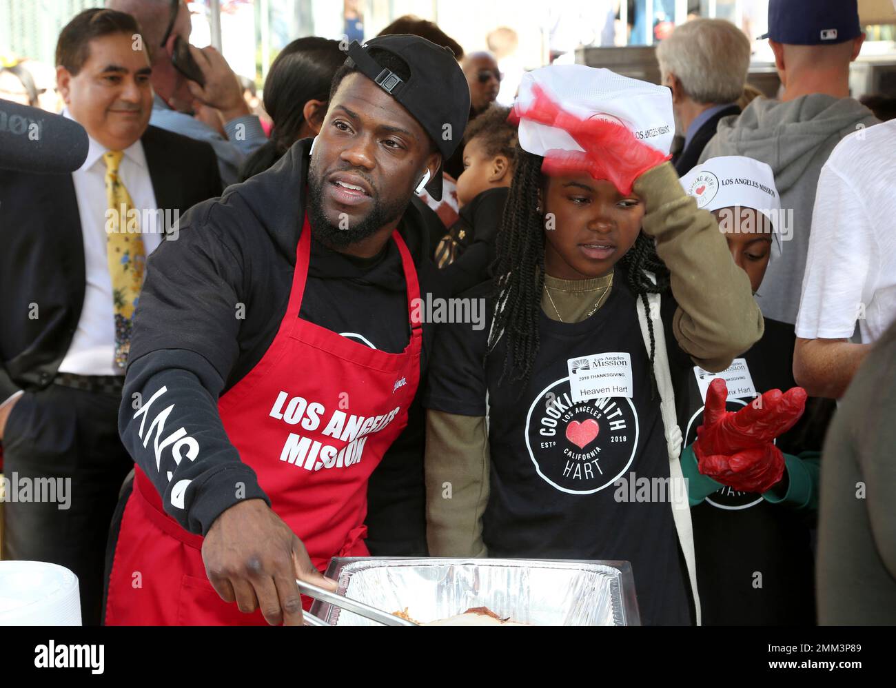 Comedian Kevin Hart, left, and his daughter Heaven Hart serve ...
