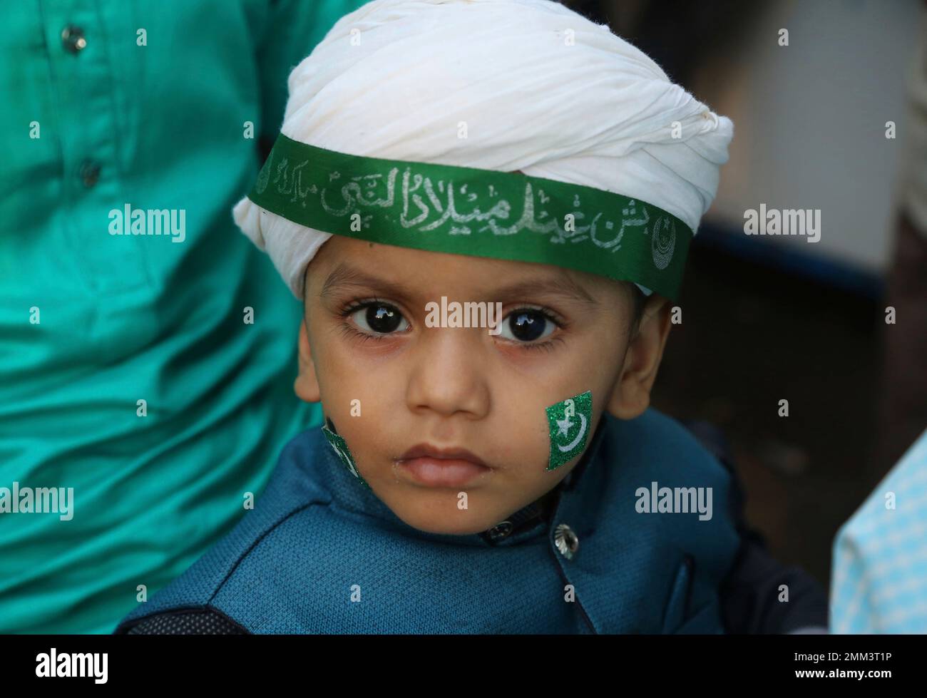 An Indian Muslim child, face painted with Islamic flag looks on as he ...