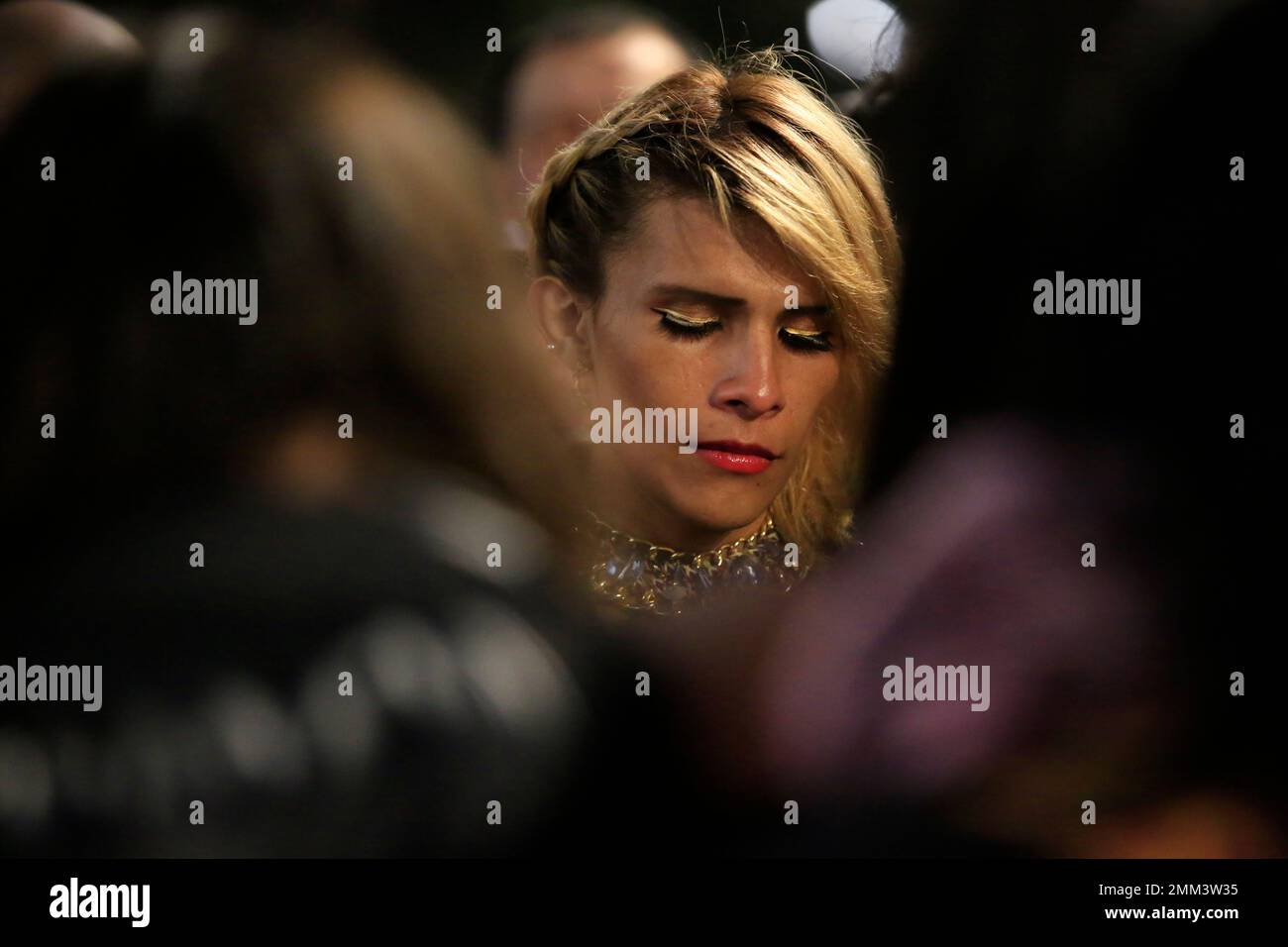 Estrella Hernandez closes her eyes as dozens of transgender women and ...