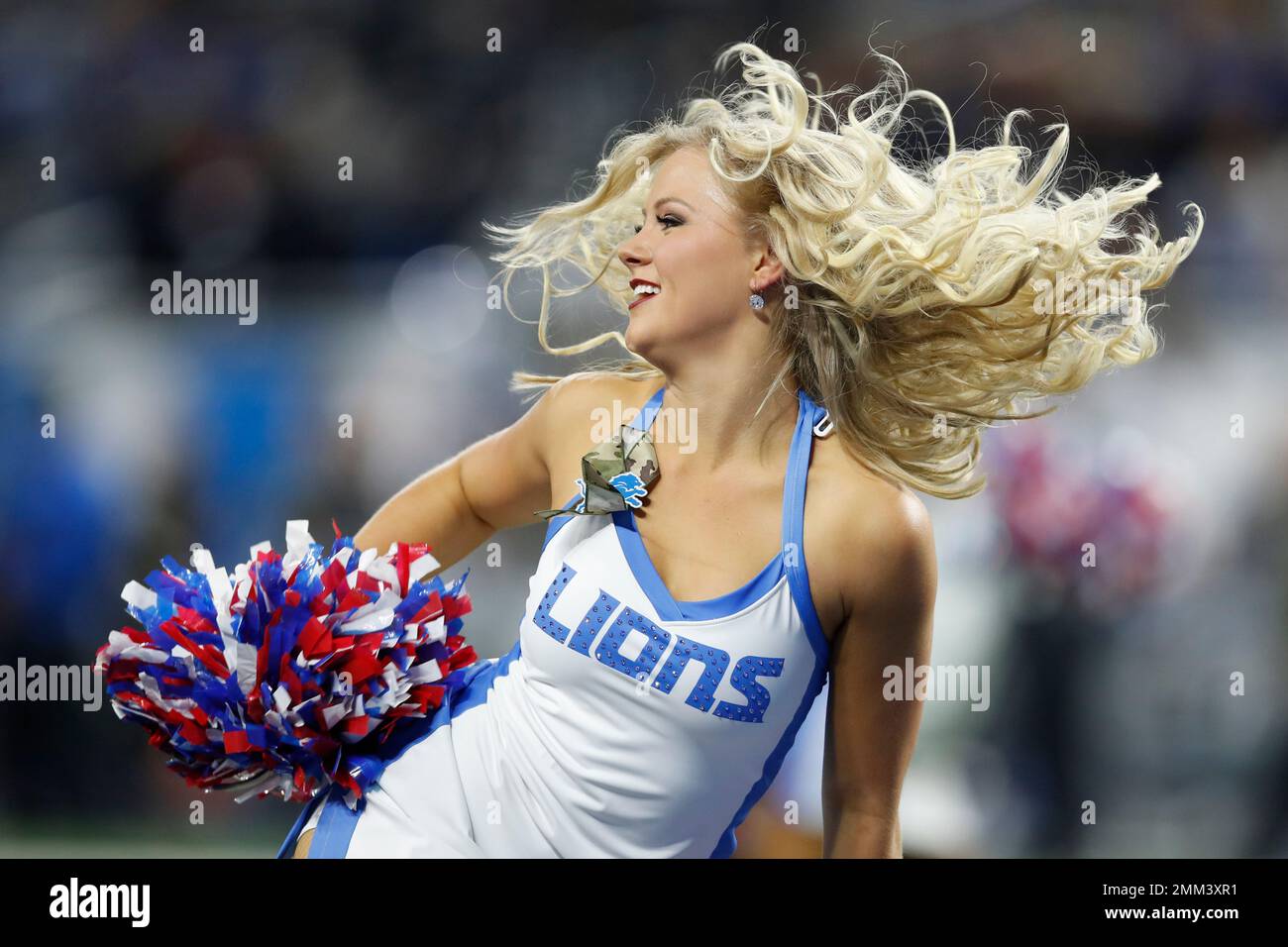 A Detroit Lions cheerleader performs during an NFL football game ...