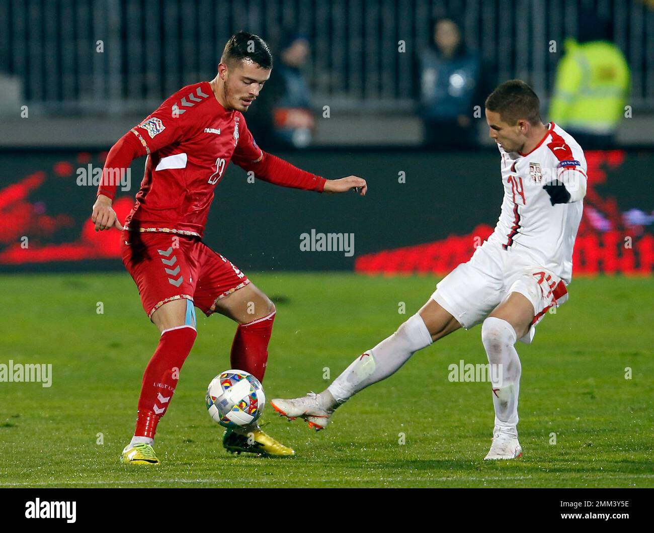 Lithuania's Rolandas Baravykas, left, duels for the ball with Serbia's ...
