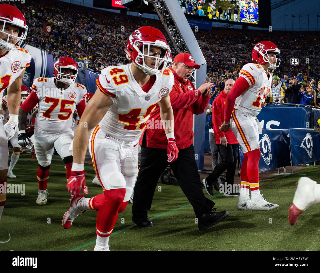 Kansas City Chiefs head coach Andy Reid, center, leads his players to ...