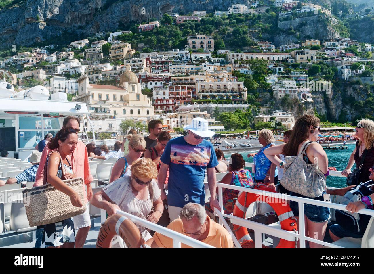 Passengers boarding a ferry calling at Positano on the Amalfi coast ...