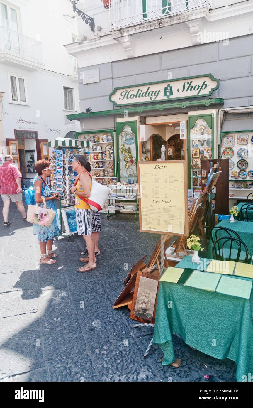People talking outside the holiday shop in Amalfi, Italy Stock Photo ...