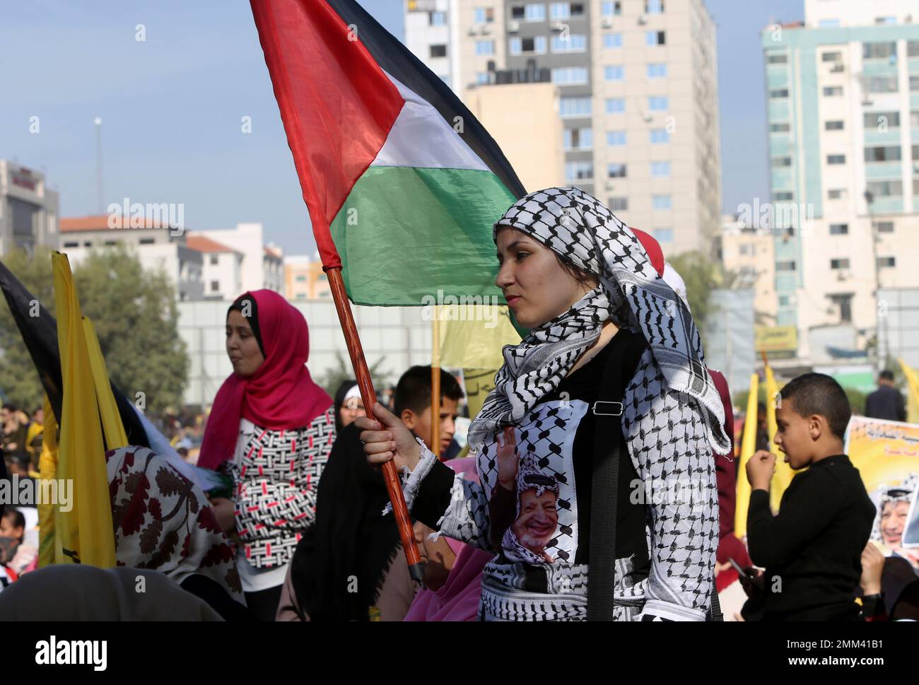 A Palestinian wave national flags and yellow Fatah flags during a rally ...