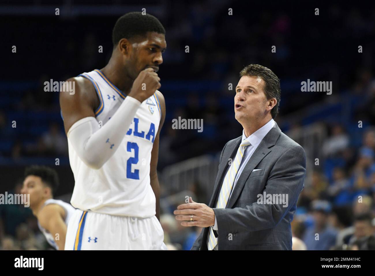 UCLA head coach Steve Alford talks with forward Cody Riley (2) during ...
