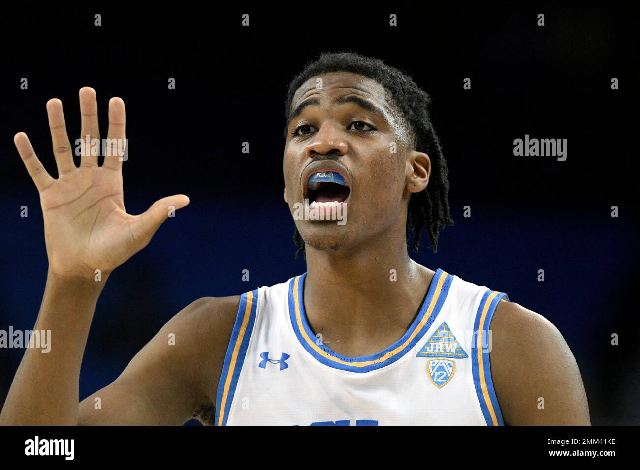 UCLA guard Chris Smith motions to teammates during an NCAA college ...