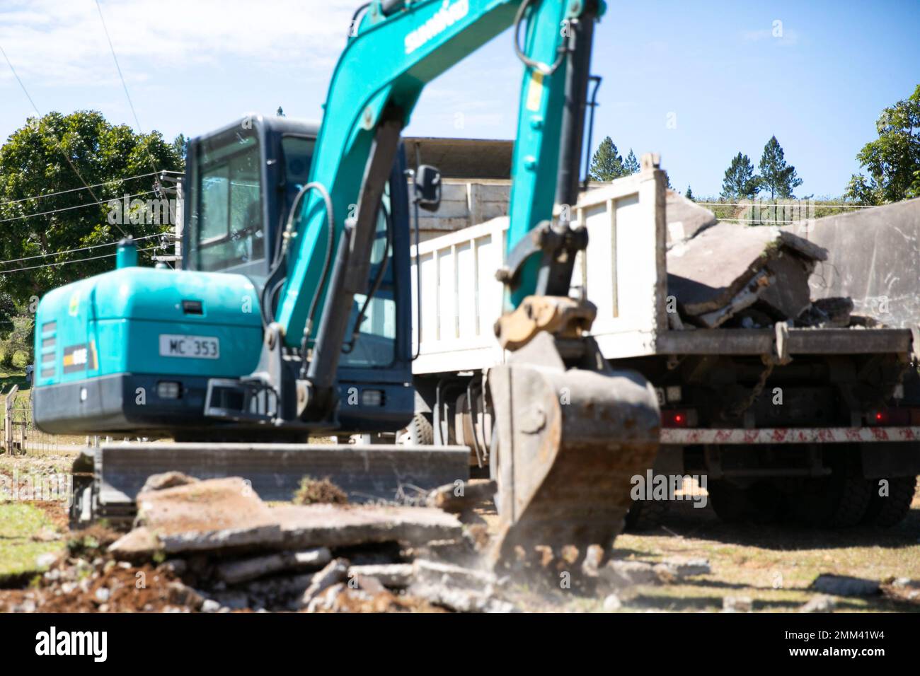 Construction workers tear up the dilapidated driveway in preparation ...