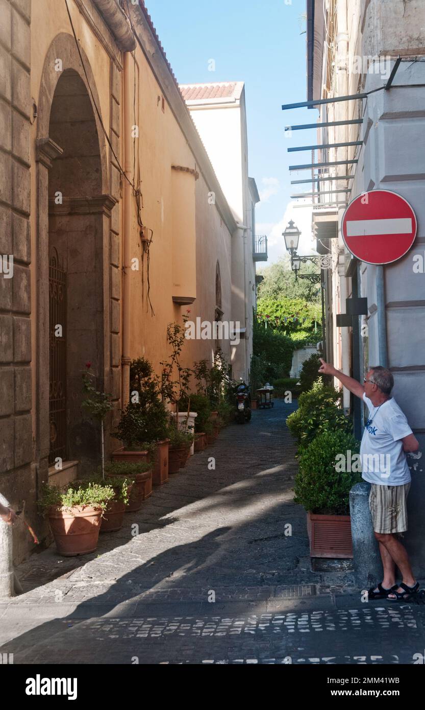 Man standing on a street corner pointing at a building in Sorrento ...