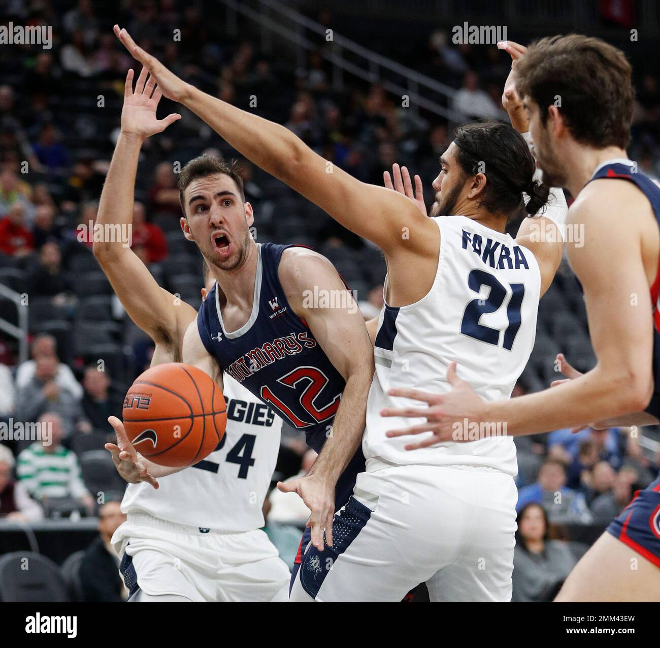 Saint Mary's Tommy Kuhse (12) passes around Utah State's Ben Fakira (21 ...
