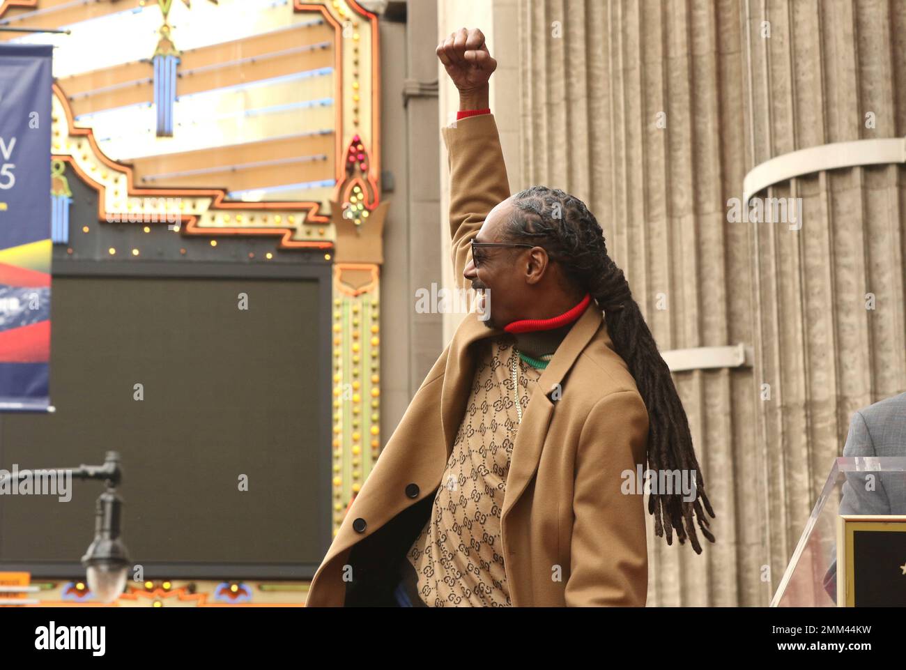 Rapper Snoop Dogg gestures to the crowd during a ceremony honoring him ...