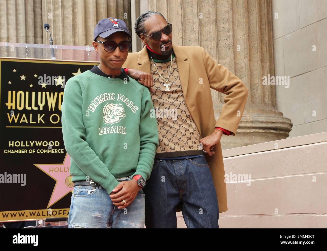 Rapper Snoop Dogg, right, poses atop his new star on the Hollywood Walk ...