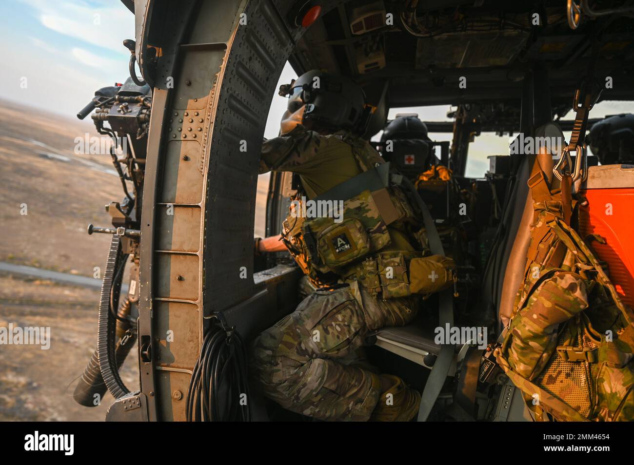 An Airman from the 55th Rescue Squadron, fires at simulated targets ...