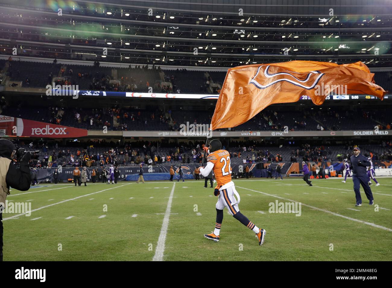 Chicago Bears defensive back Kevin Toliver (22) carries a large flag ...