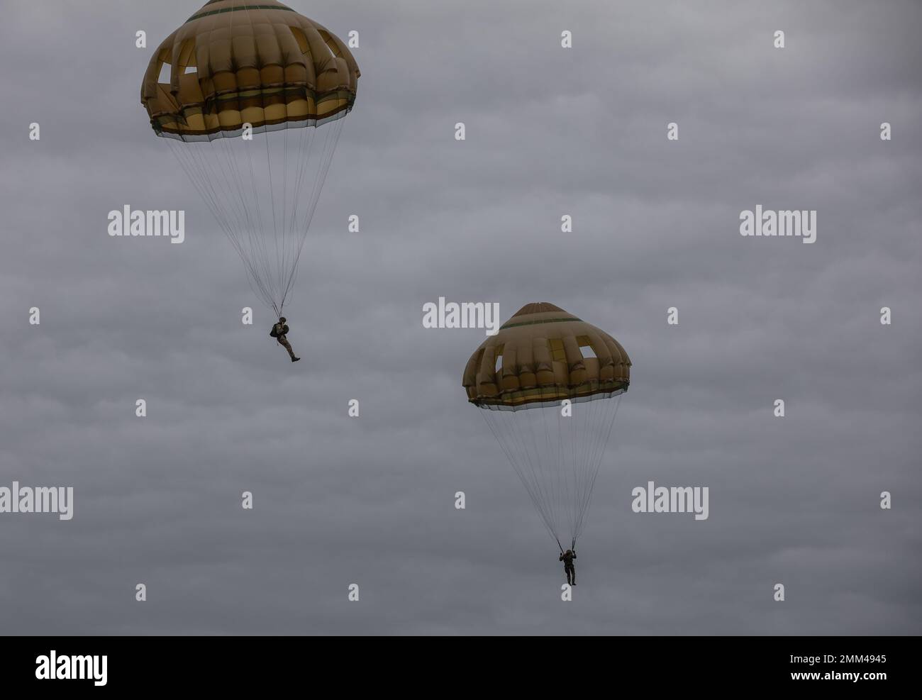 A group of U.S. Army and European Paratroopers decends to the Drop Zone ...