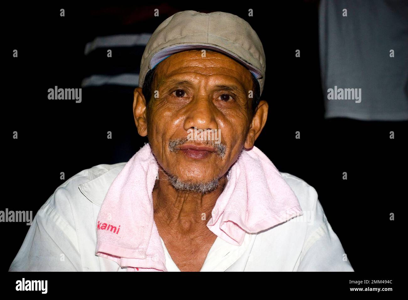 Portrait of an old man from Indonesia, he looks serious at the camera ...