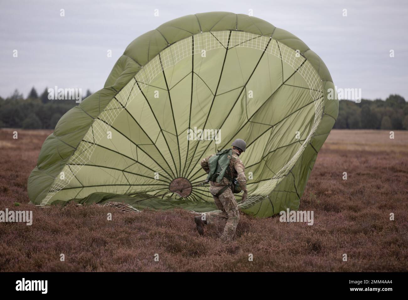 A Dutch Paratrooper gets dragged by his German T-10 parachute during ...