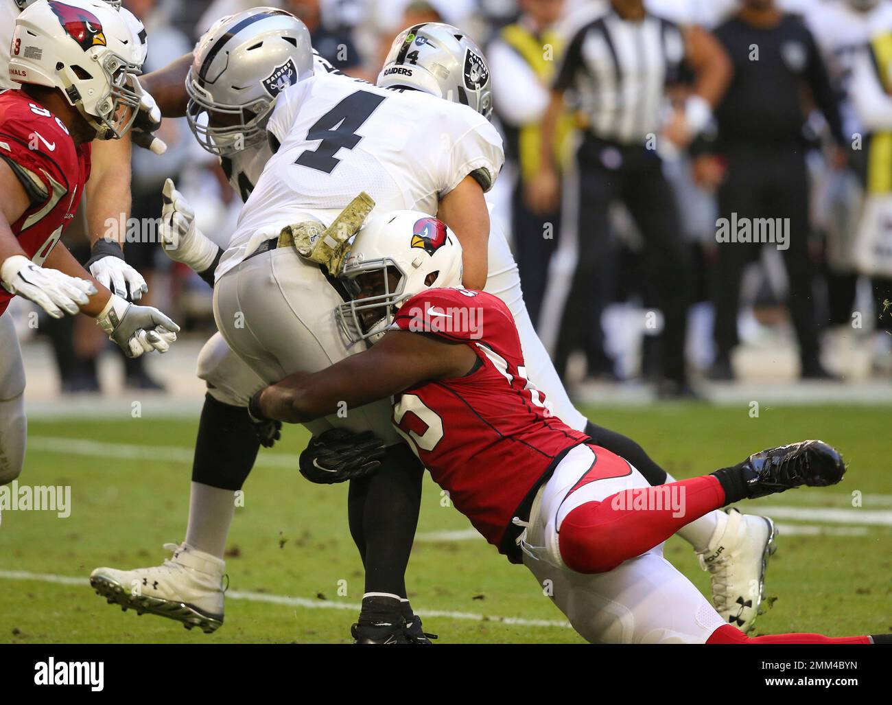 Oakland Raiders quarterback Derek Carr (4) is sacked by Arizona ...