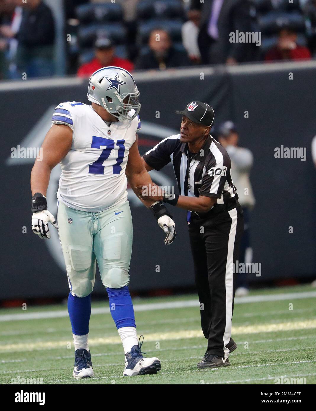 Dallas Cowboys offensive tackle La'el Collins (71) is notified by line ...