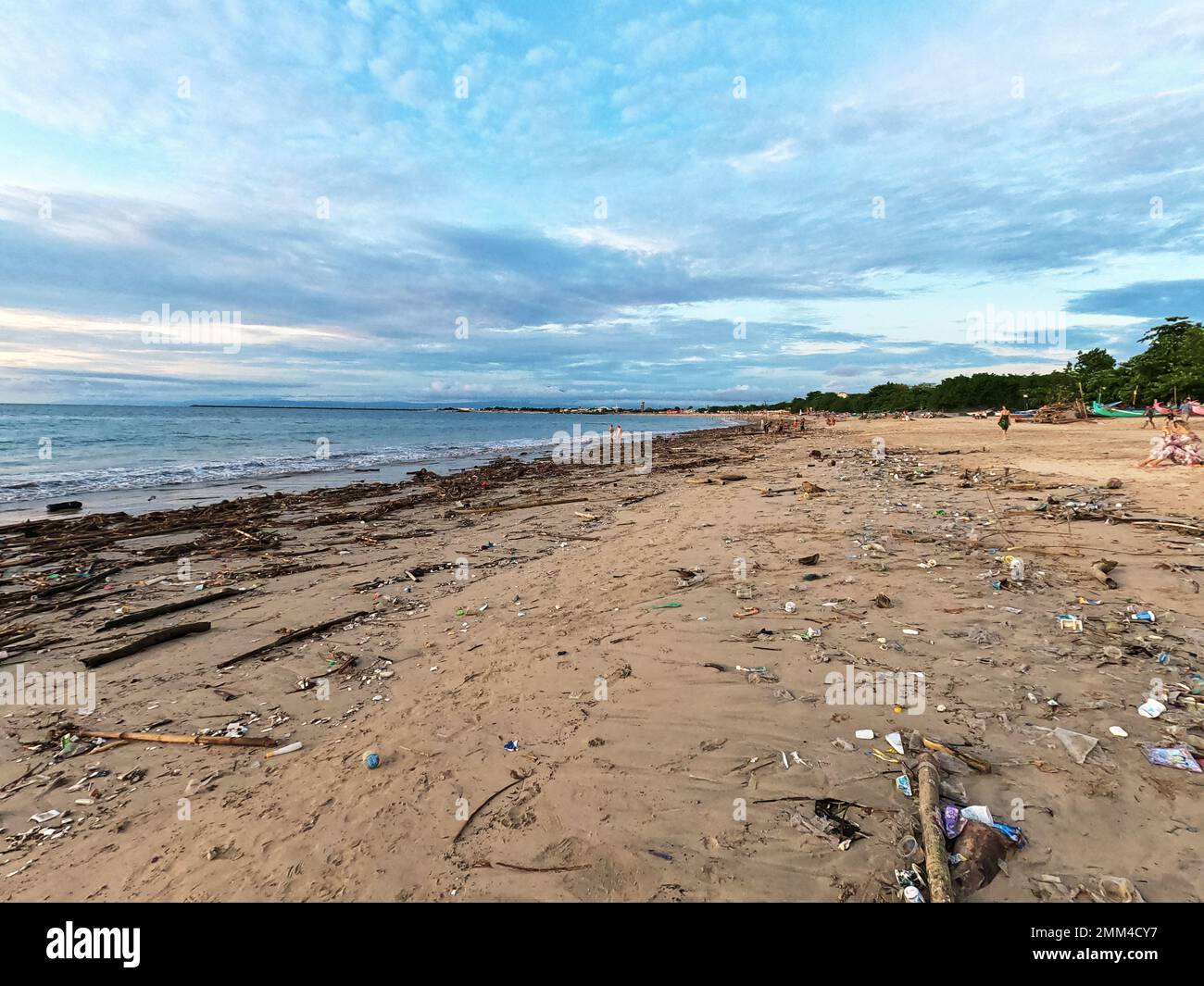 Garbage washed up on the beach from the ocean after high tide. An ...