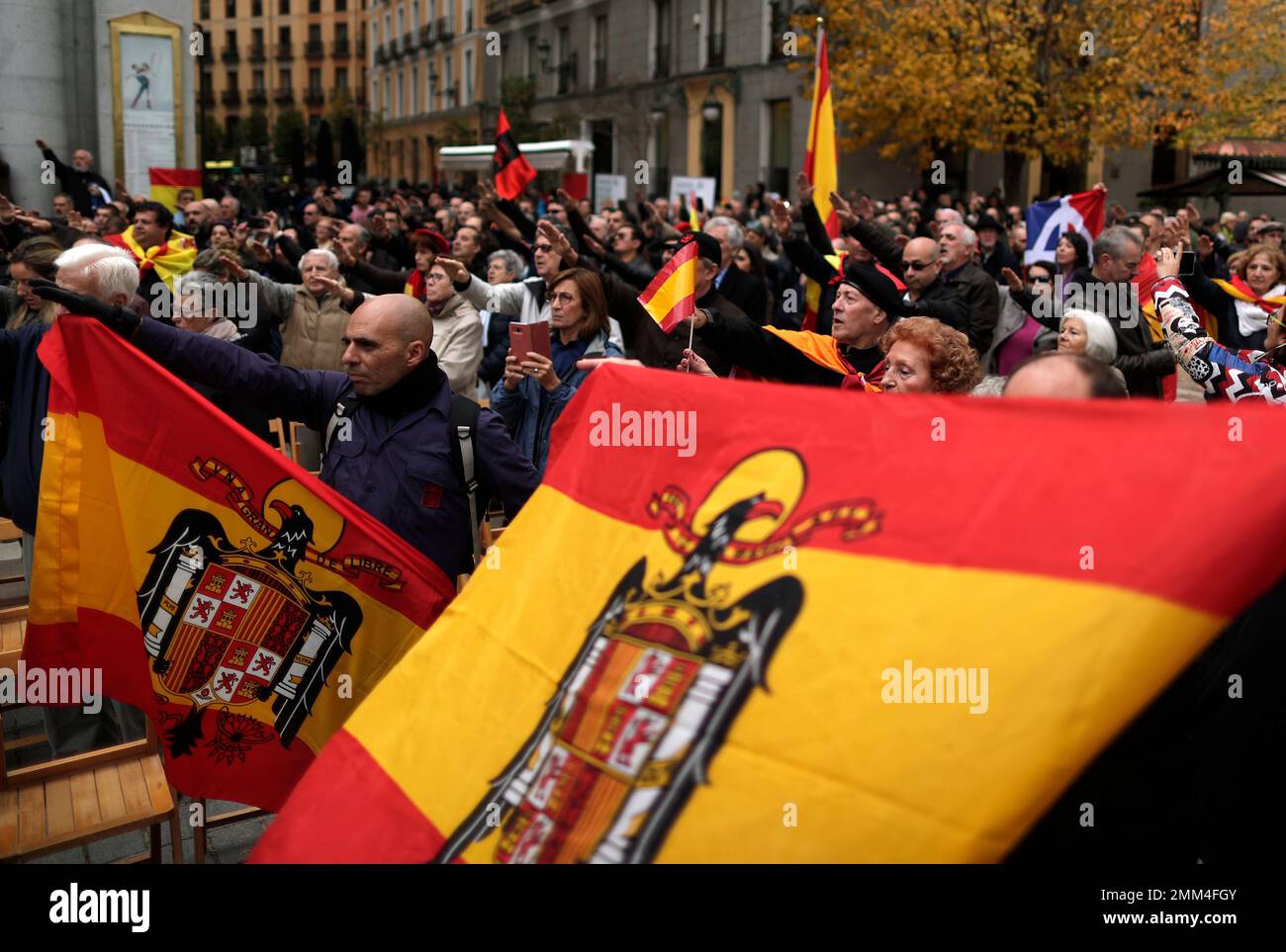 Supporters rise their right arm to salute the fascist anthem to ...