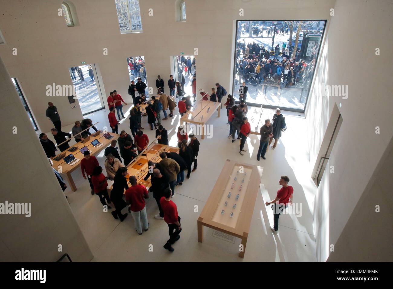 Customers stroll in side the new Apple store at the Champs Elysees ...