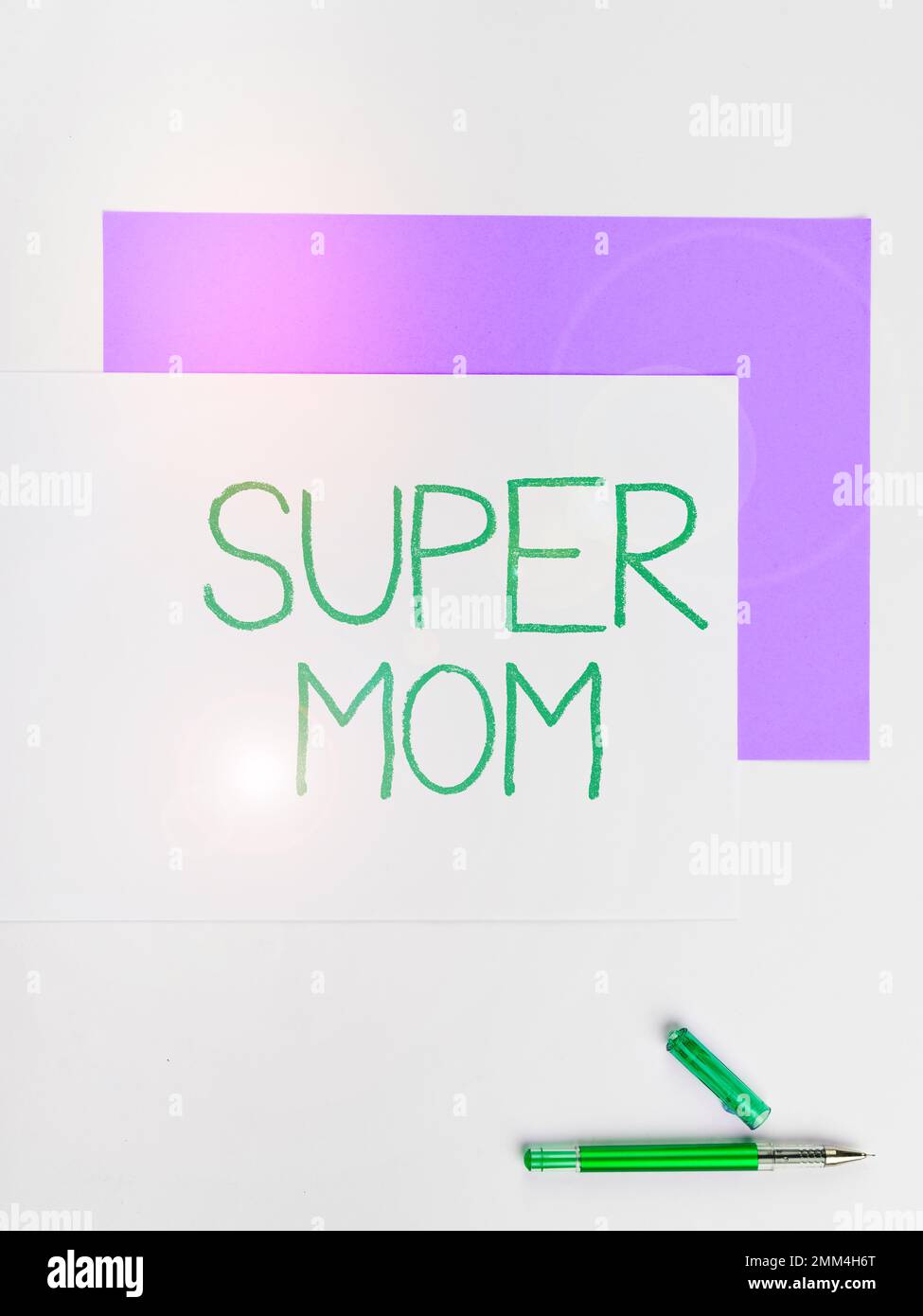 Hand writing sign Super Mom. Word Written on a mother who can combine ...