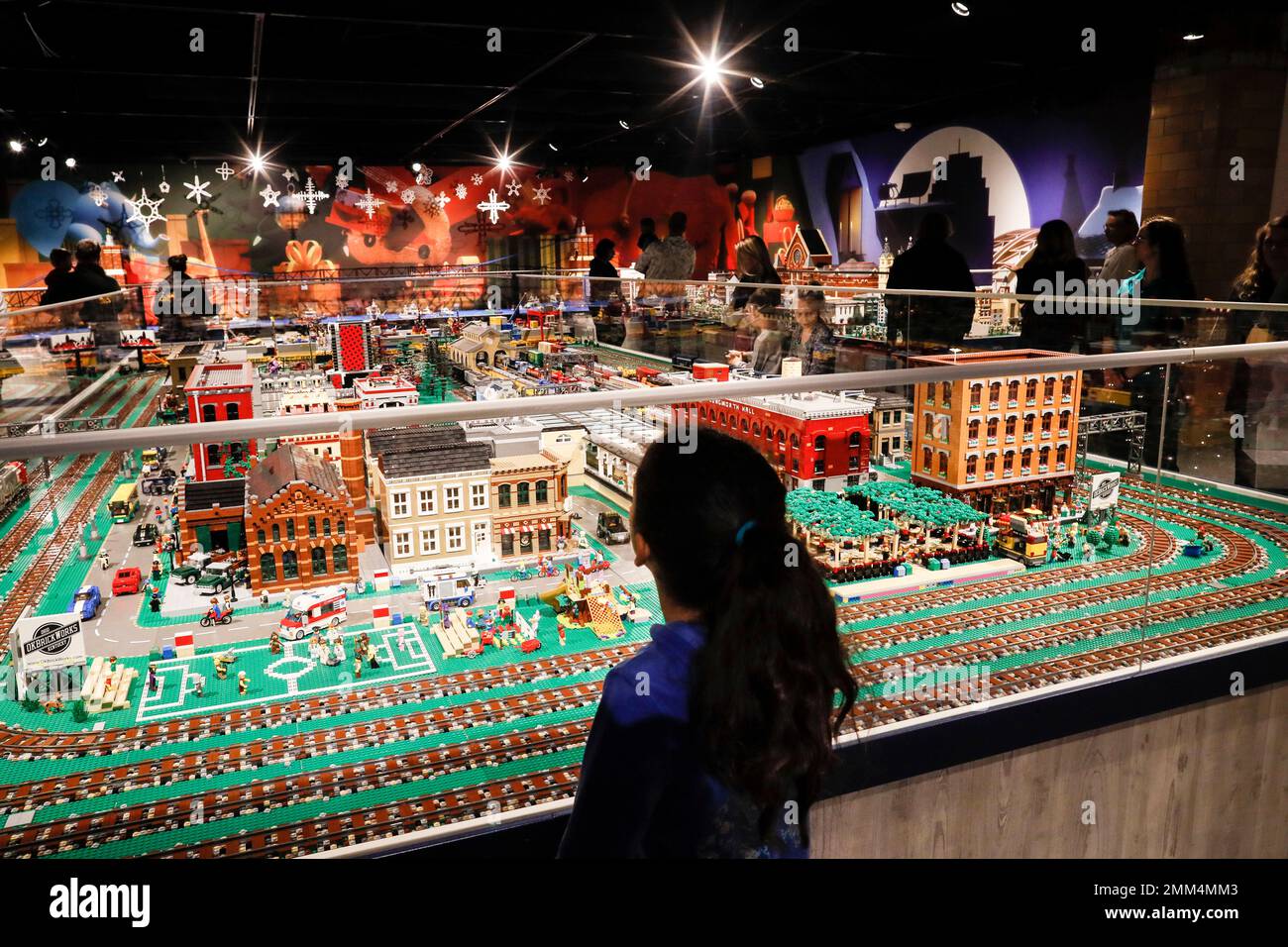 Visitors browse a holiday exhibit featuring lego models of local ...
