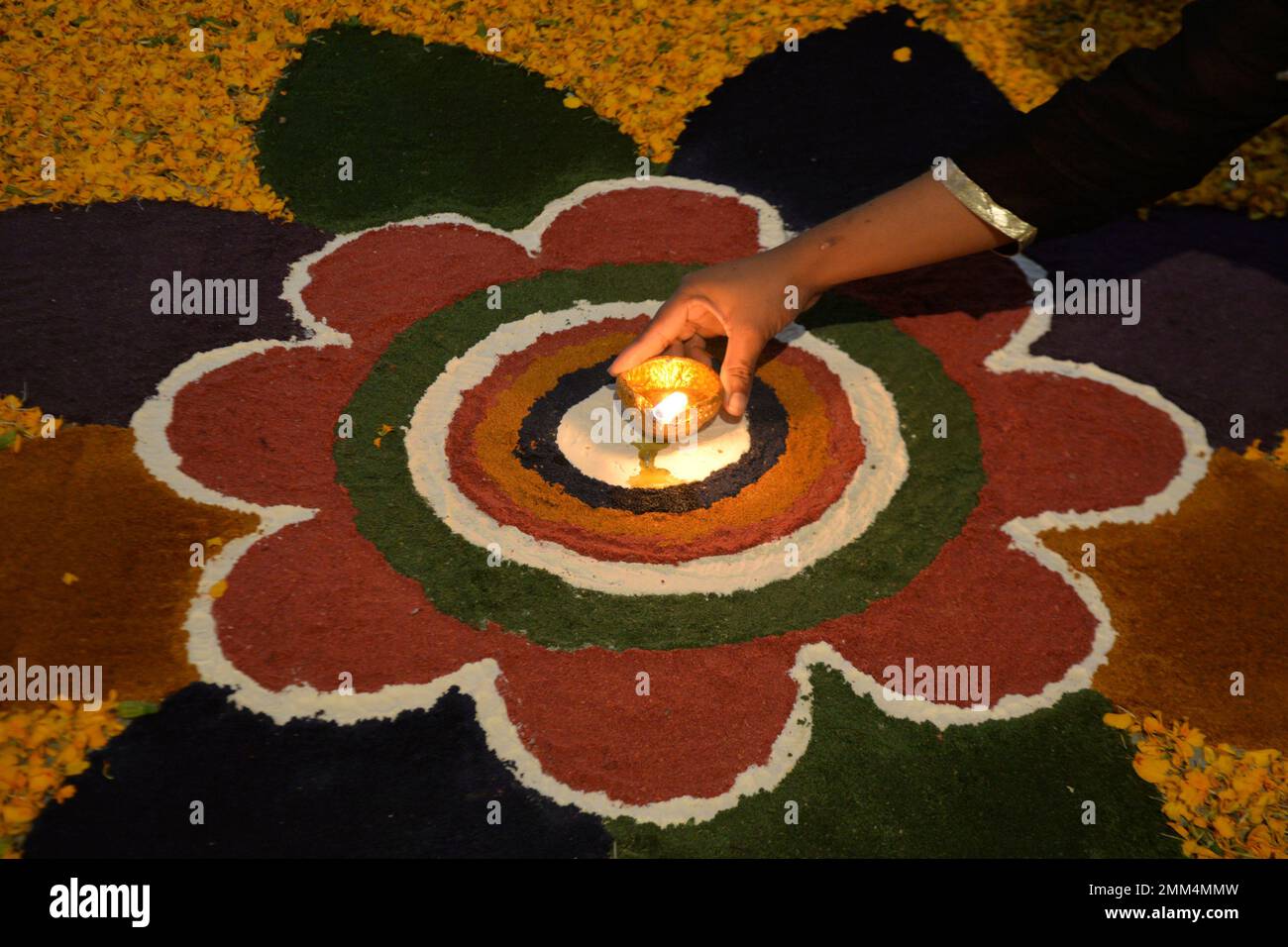 A Pakistani Hindu girl lights an earthen lamp during the celebration of ...
