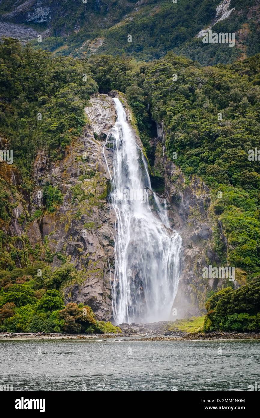 Bowen Falls cascading over rocks into Milford Sound in Fiordland on the ...