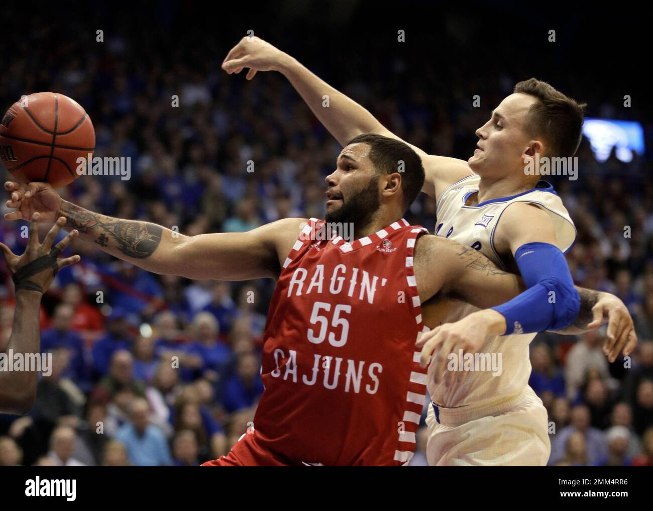 Louisiana Lafayette forward Justin Miller (55) is fouled by Kansas ...
