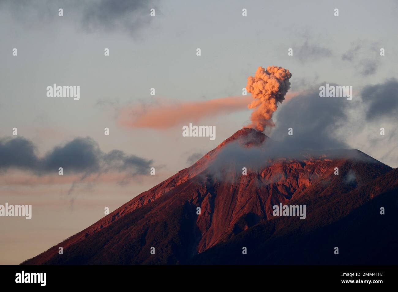 Volcan de Fuego or Volcano of Fire blows outs a thick cloud of ash in ...