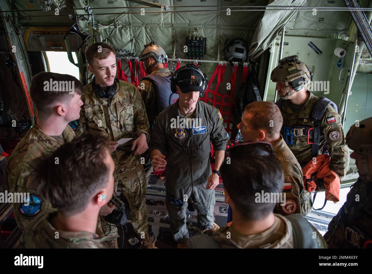 U.S. Air Force and Polish military members discuss flight plans as part ...