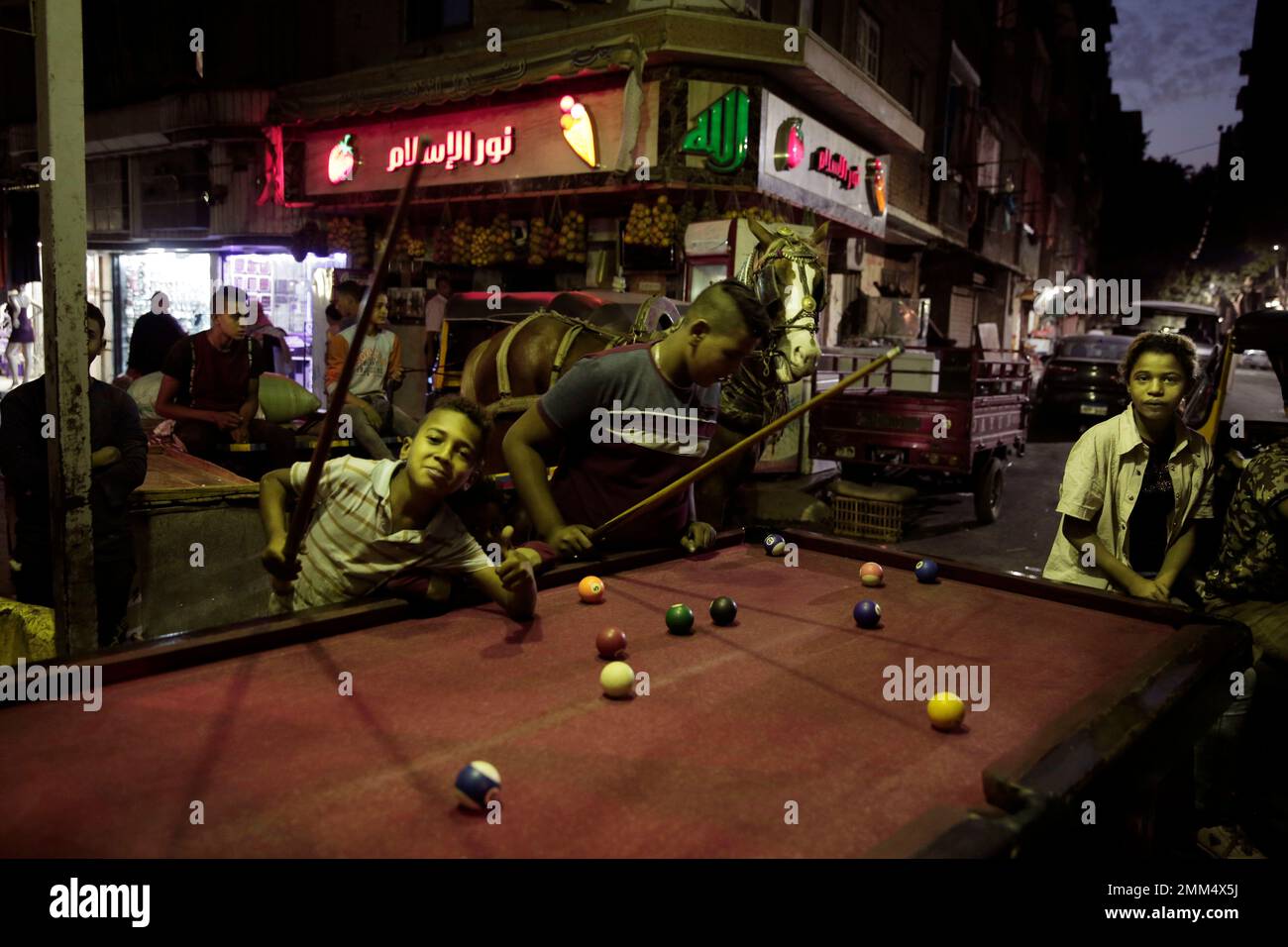 In this Oct. 23, 2018 photo, children play billiards in Shubra, Egypt ...